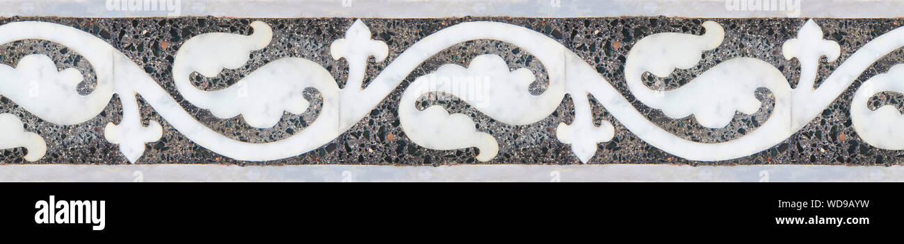 Old carved stone frame with floral pattern of the medieval frieze of ...