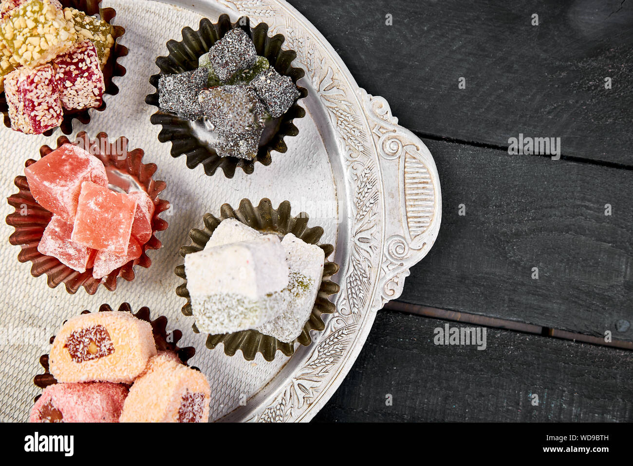 Set of various Turkish delight in traditional silver bowl on metal tray ...