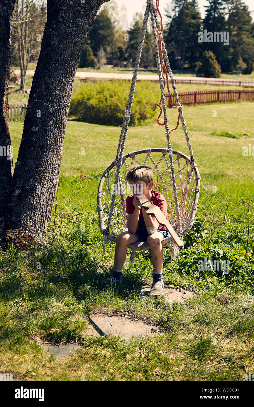 Boy sitting tree hi-res stock photography and images - Alamy