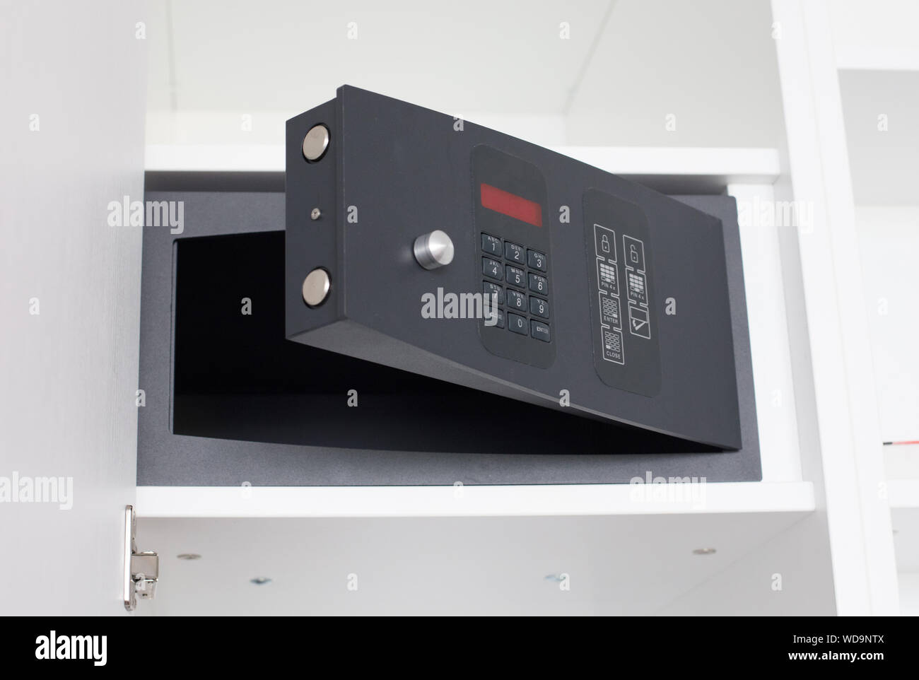 Safe box in a hotel room, white closet Stock Photo - Alamy