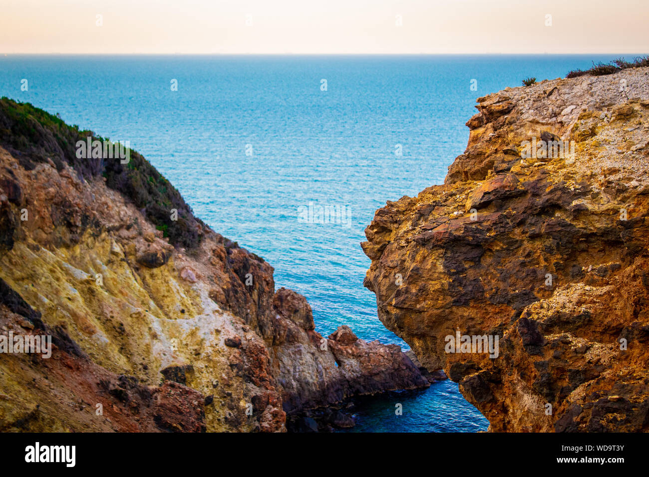 Exotic cliff rock, background sea Stock Photo - Alamy