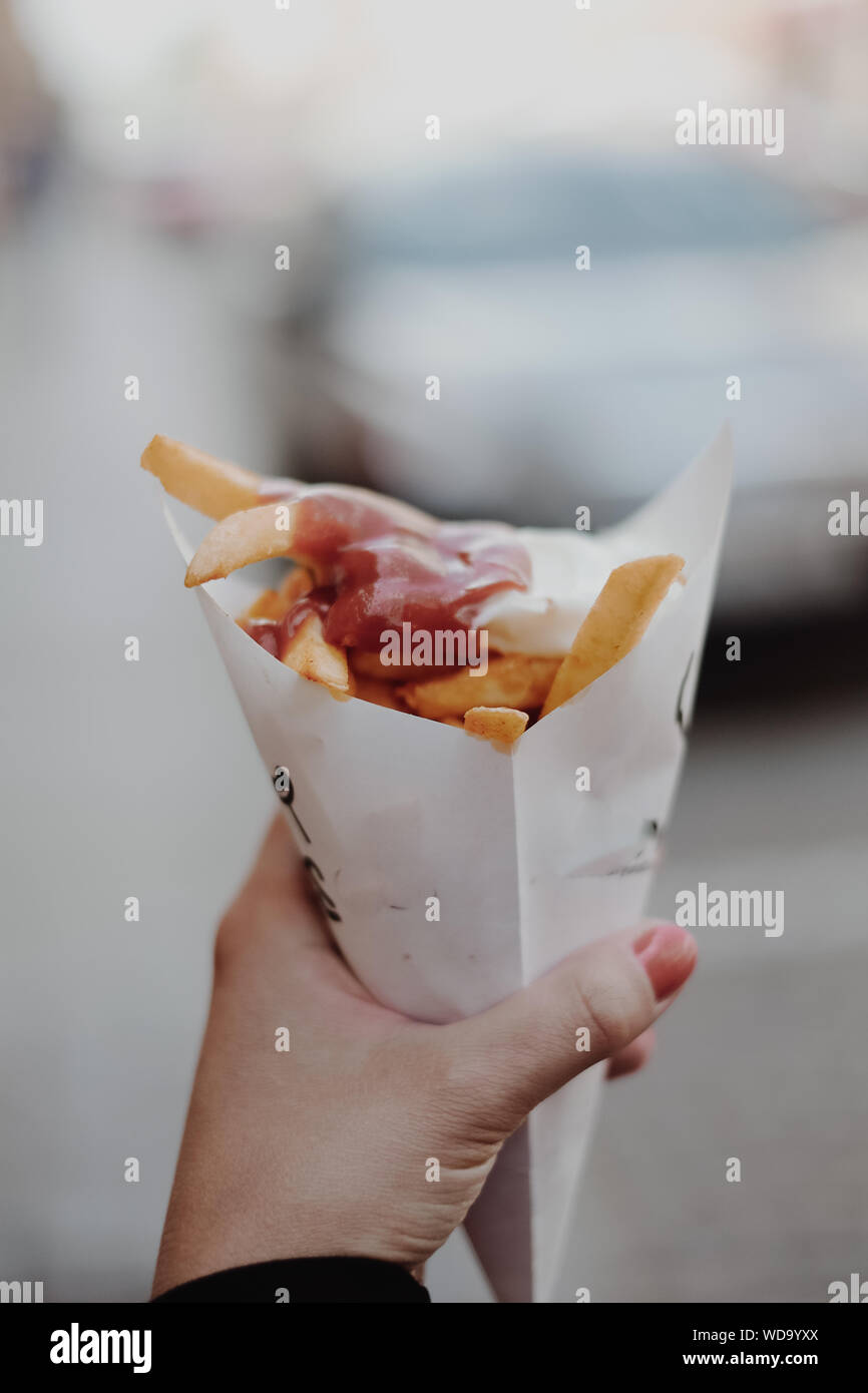 Hand holding french fries in hi-res stock photography and images - Alamy