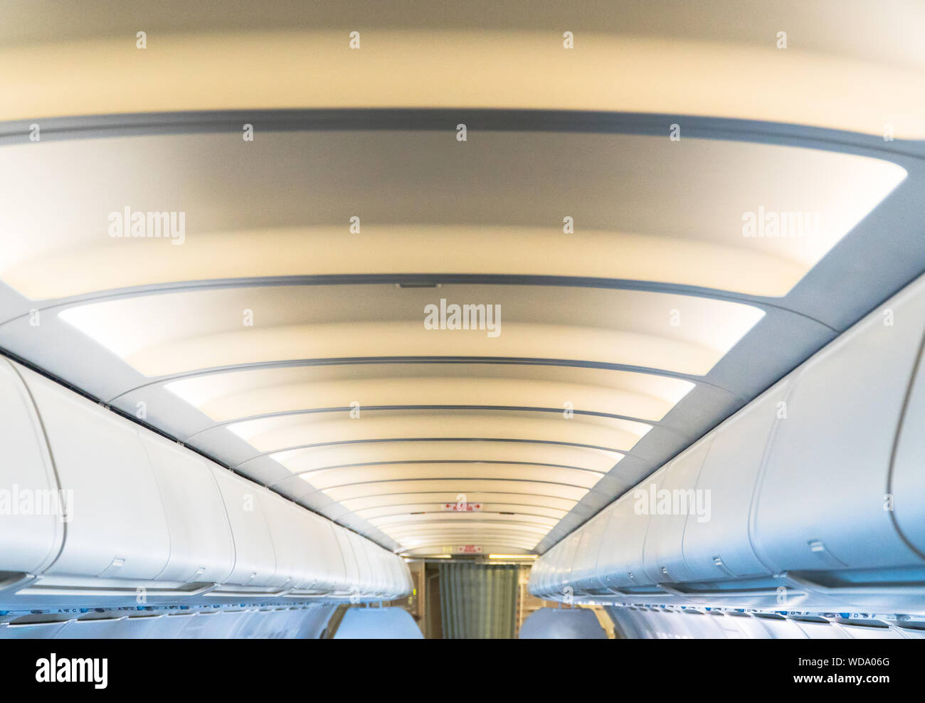 Blurred photo of the aircraft interior. The ceiling of the airplane ...