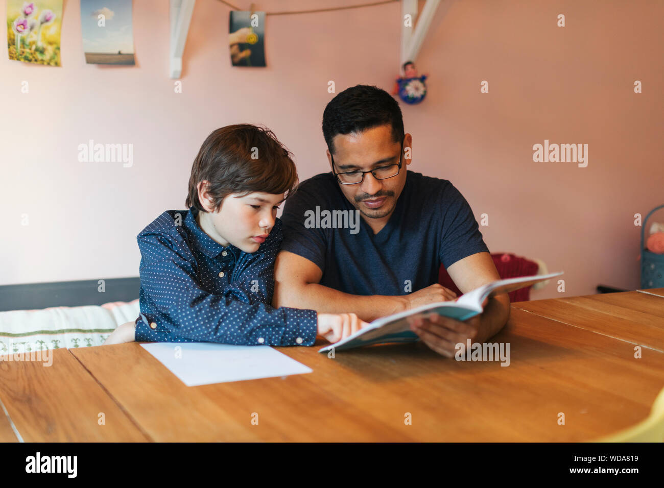 Helping his son to do homework hi-res stock photography and images - Alamy