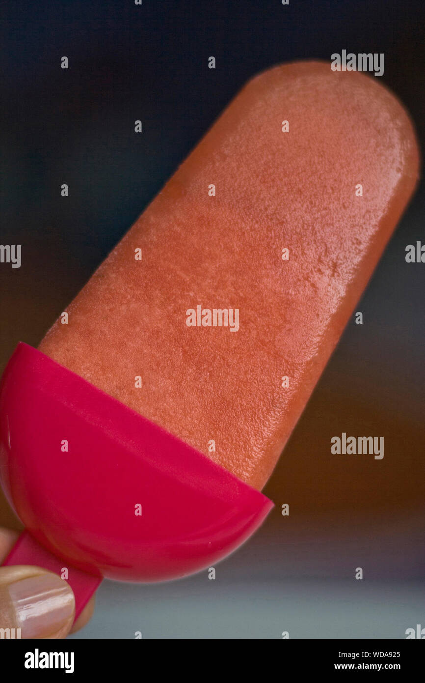 Nice watermelon iced pole hold by a hand with a dark background Stock ...