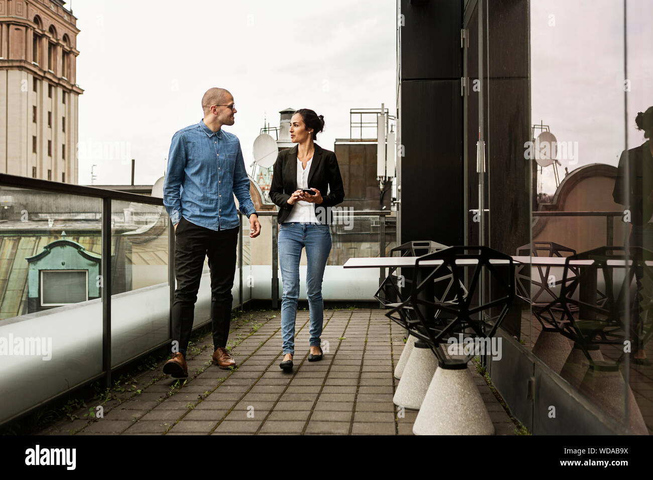 Two people talking on balcony hi-res stock photography and images - Alamy