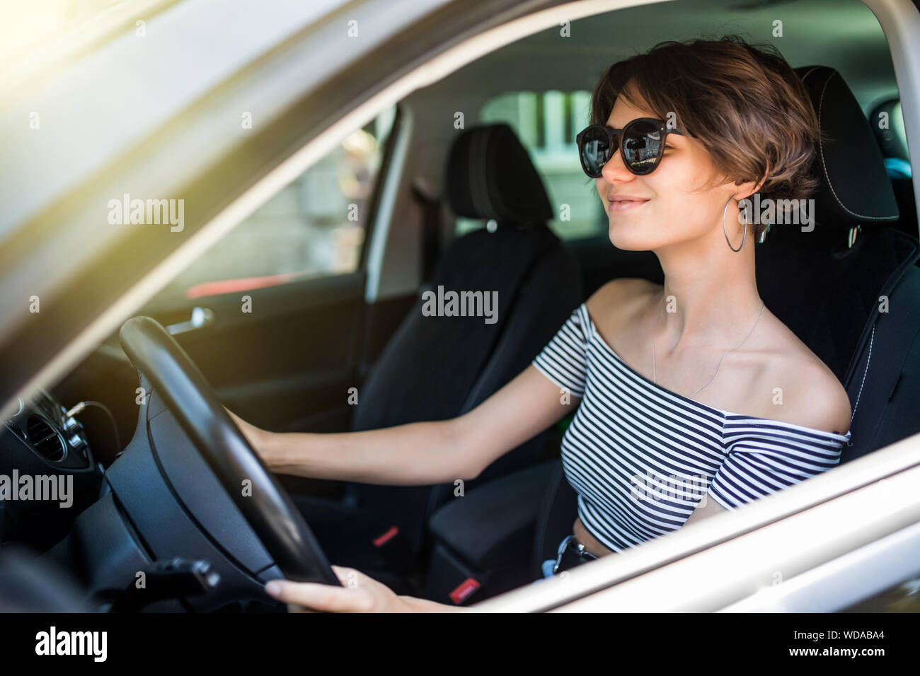 Side View Of A Young Happy Woman Driving Car Stock Photo - Alamy