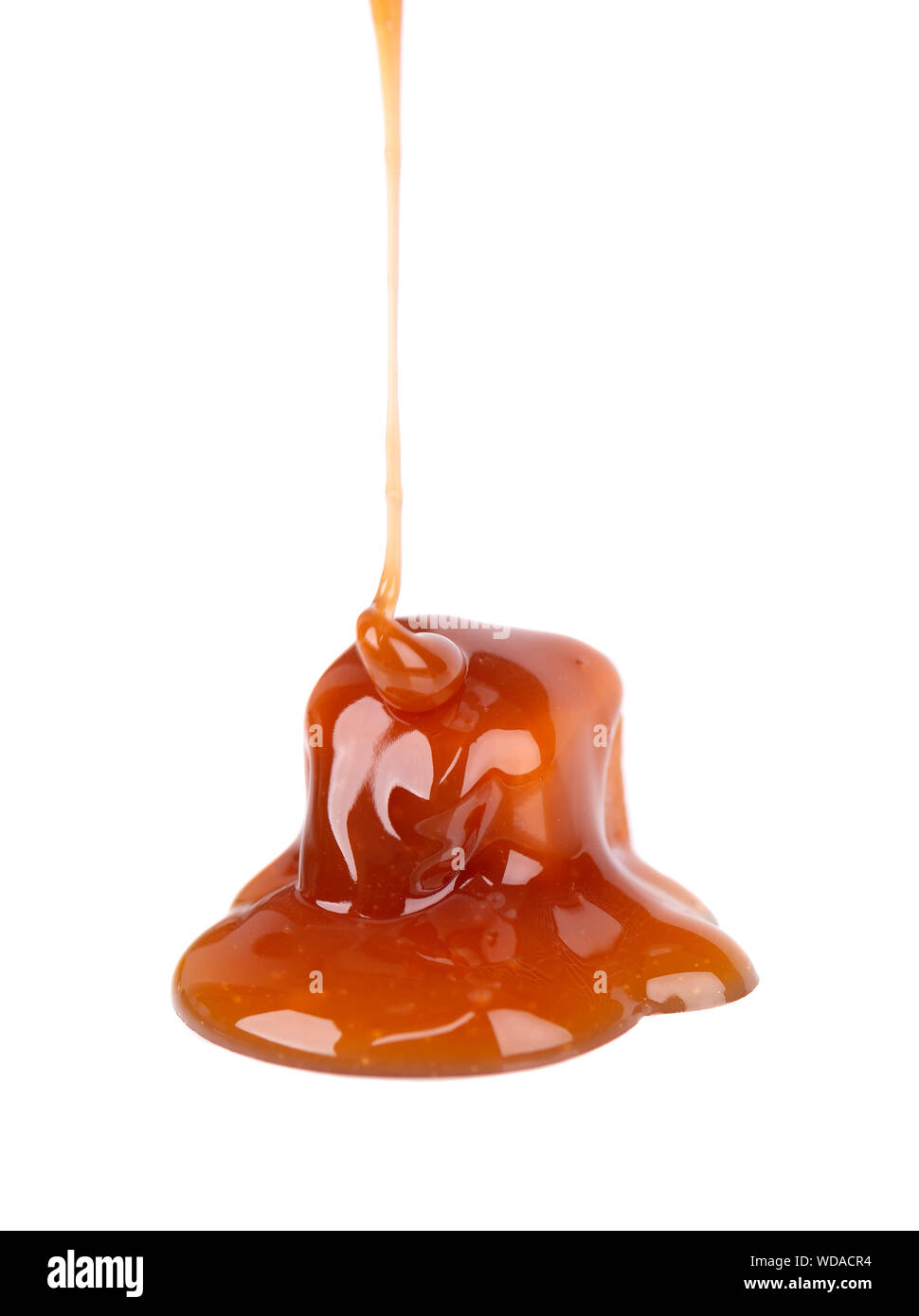 Sweet caramel candies and sauce, isolated on white background ...