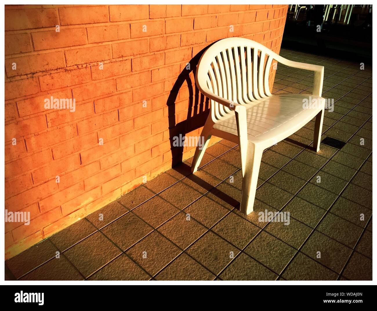 Chair against wall Cut Out Stock Images & Pictures - Alamy