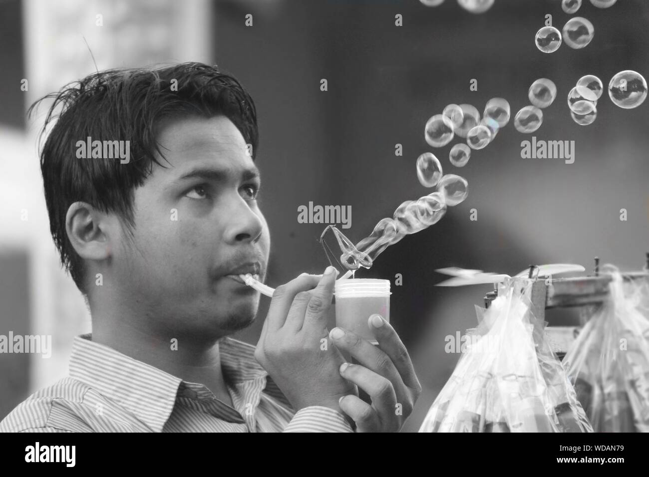 Indian man blowing bubbles hi-res stock photography and images - Alamy