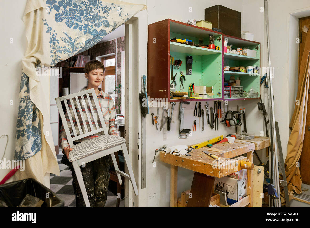 Woman carrying furniture hi-res stock photography and images - Alamy
