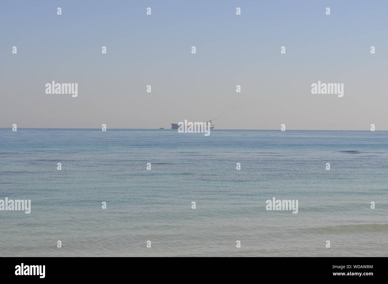 Ship in the middle of the sea from a distant Stock Photo - Alamy