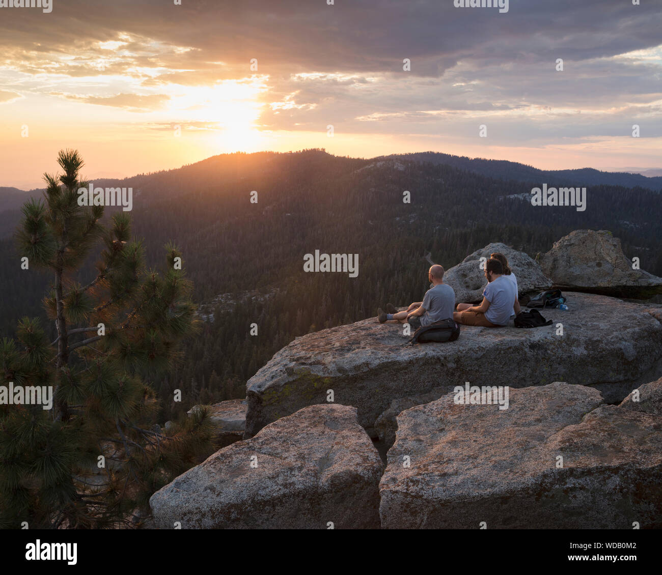 Three men sitting on rock hi-res stock photography and images - Alamy