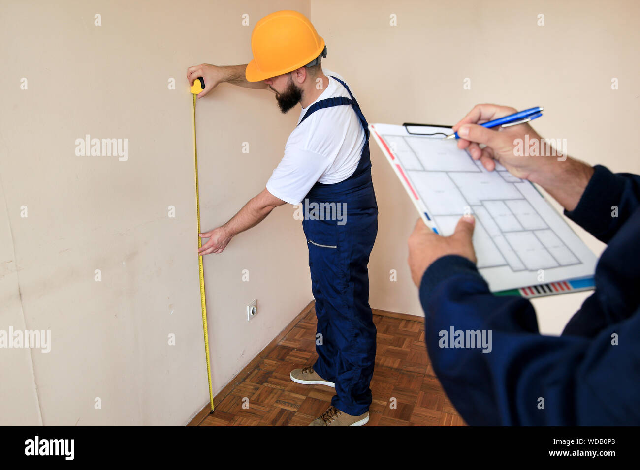 Engineer, contractor and project manager with his colleague ...