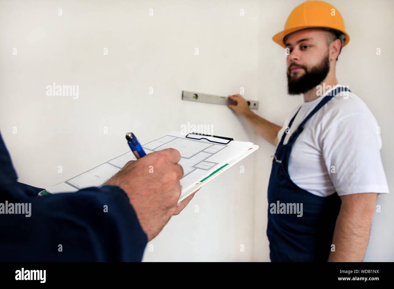 Engineer, contractor and project manager with his colleague ...