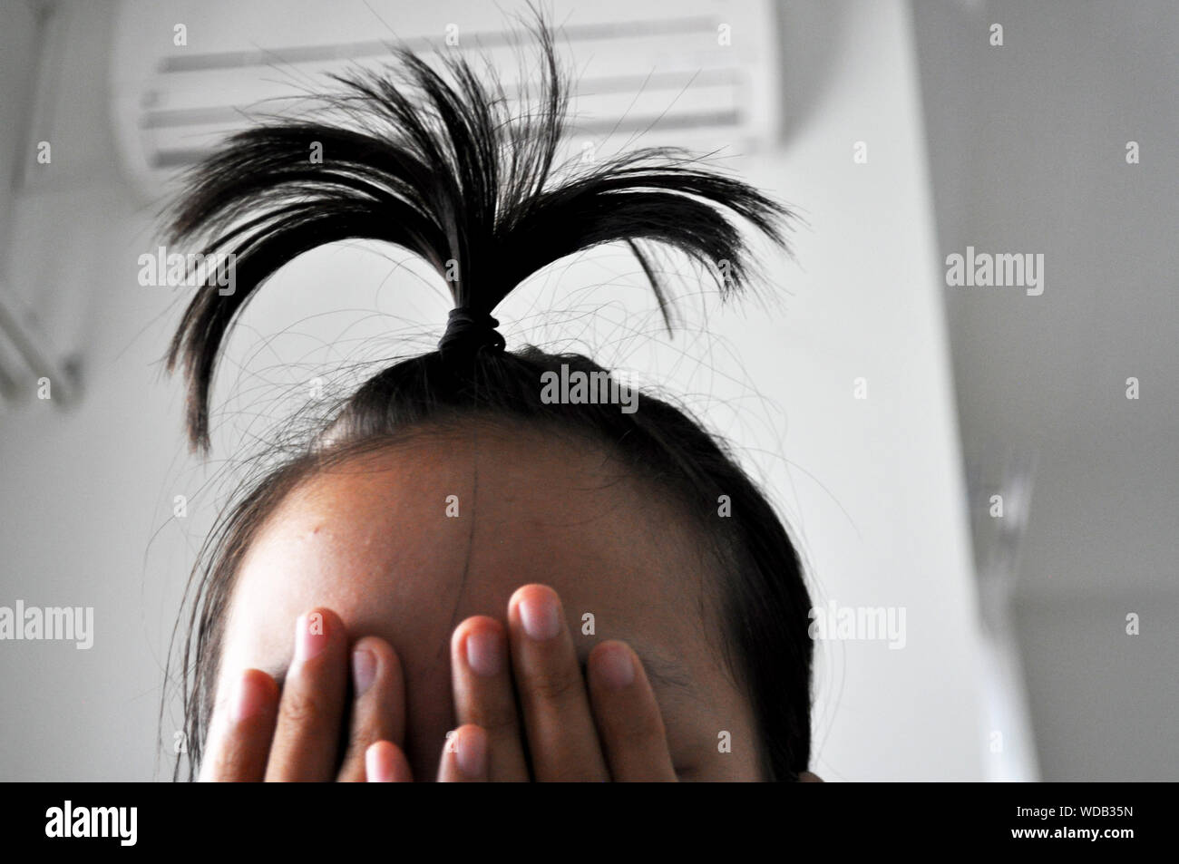 Shy girl hiding hi-res stock photography and images - Alamy