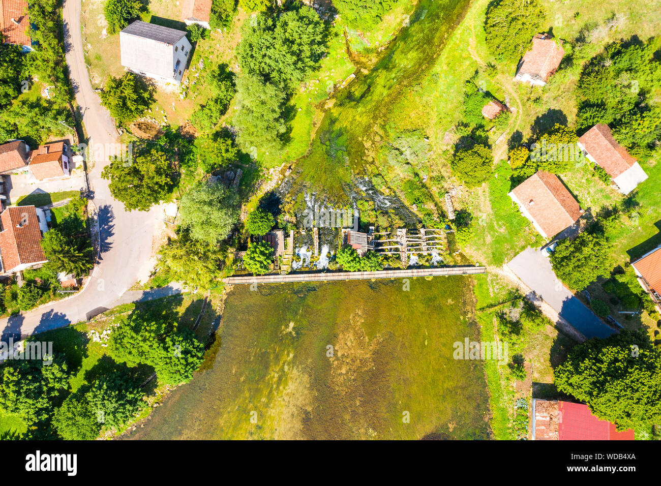 Tonkovic vrilo, river source of Gacka and wooden bridge over the river ...
