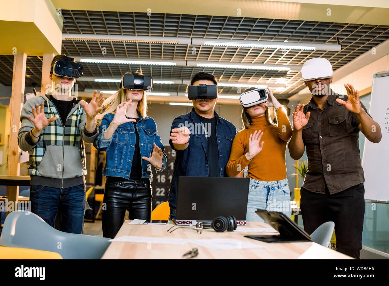 Teamwork trying virtual reality glasses for work in creative office ...