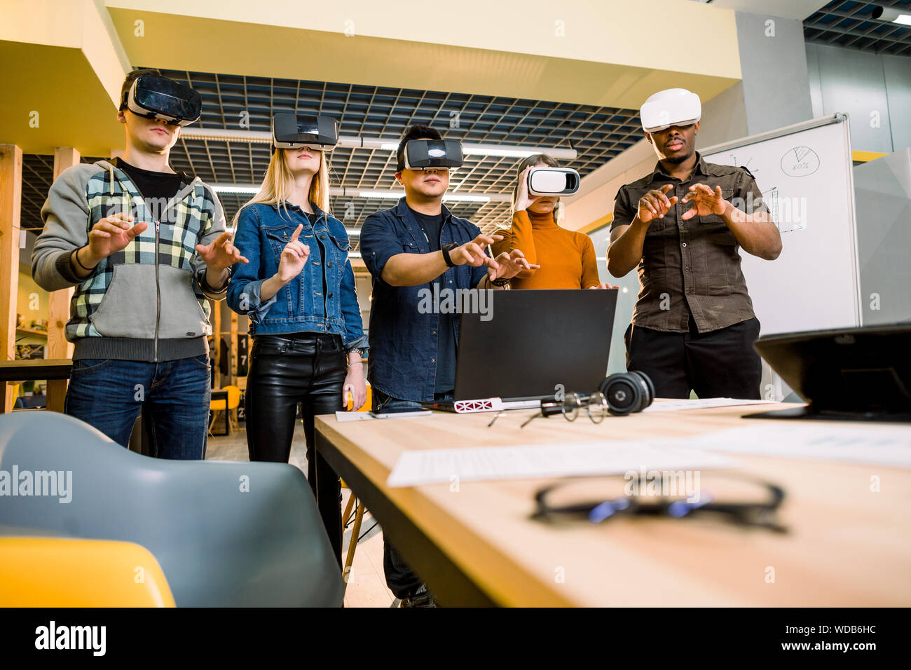 Team of developers working with virtual reality glasses during a ...
