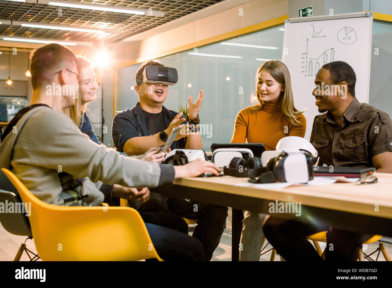 Teamwork trying virtual reality glasses for work in creative office ...
