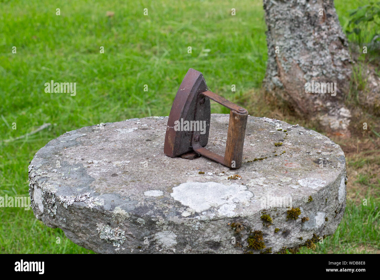 Old iron on stone stand outside Stock Photo - Alamy