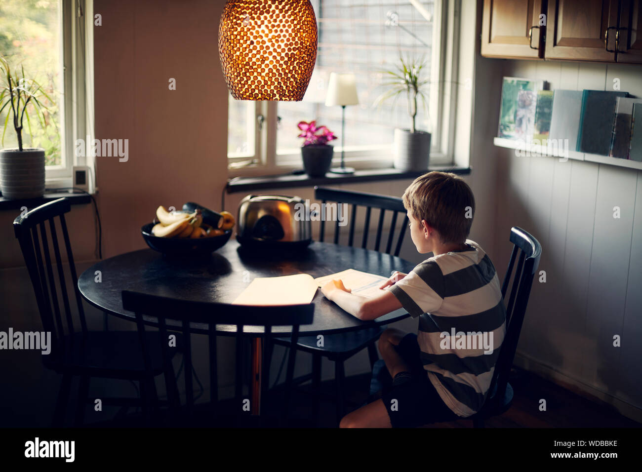 Boy sitting on the dining table hi-res stock photography and images - Alamy