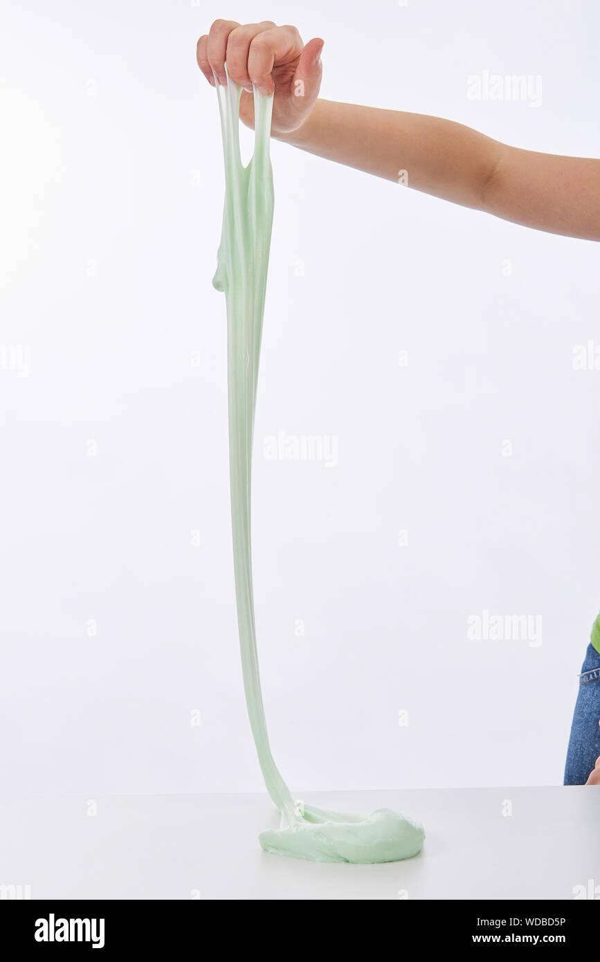 Child hand playing with slime. Isolated on white background Stock Photo ...