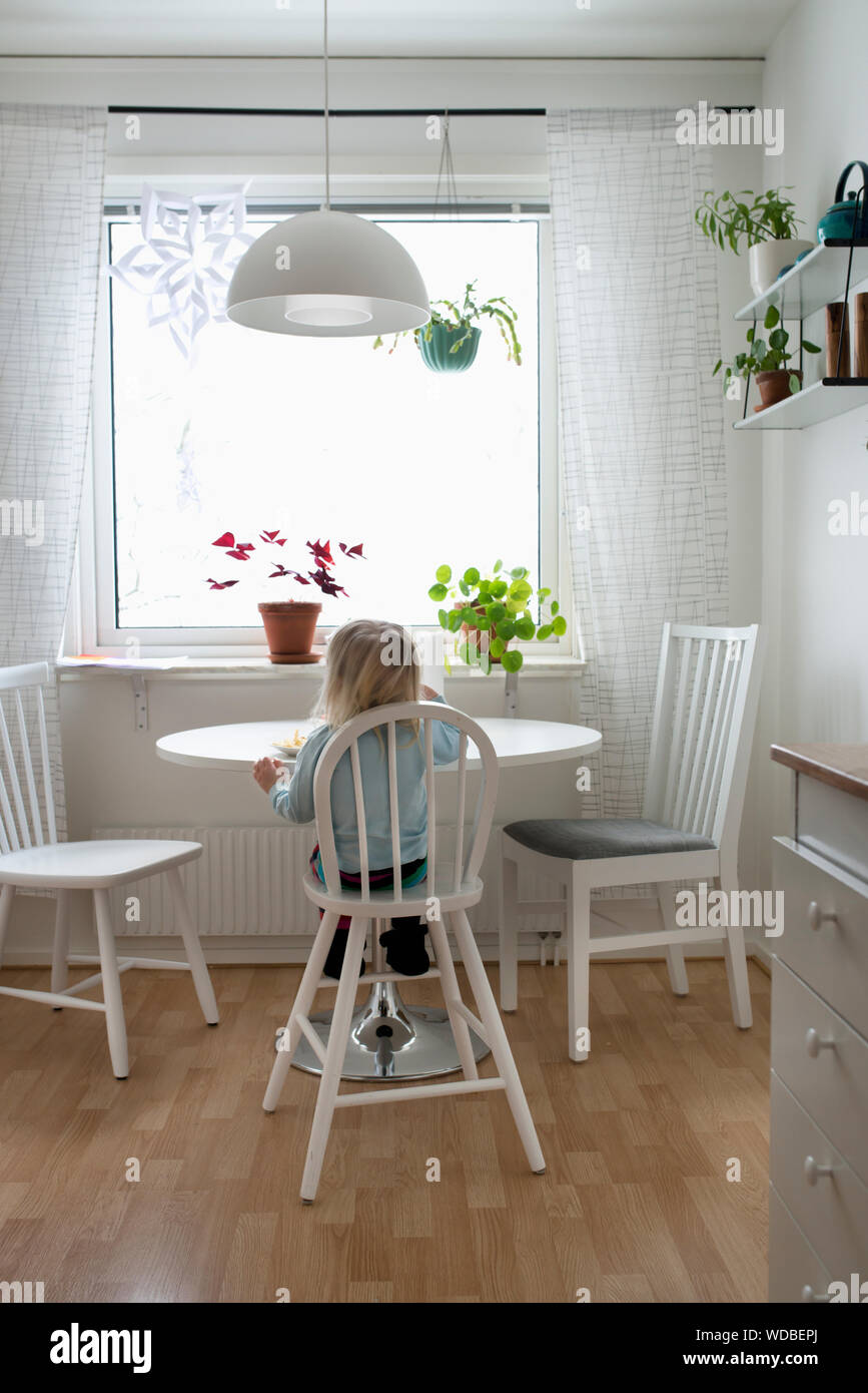 Girl sitting table hi-res stock photography and images - Alamy