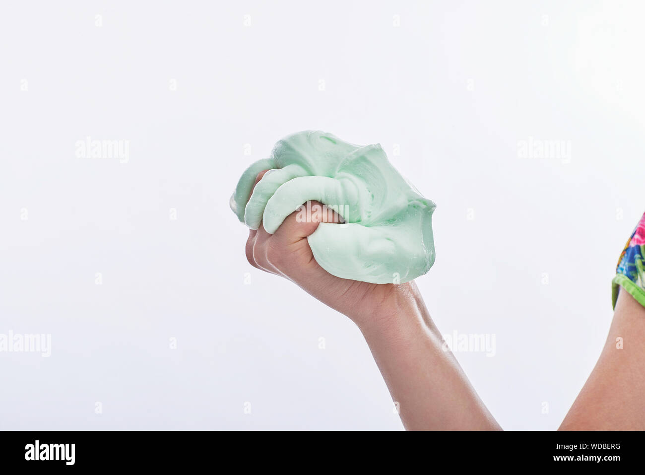 Hand squeezing green slime hi-res stock photography and images - Alamy
