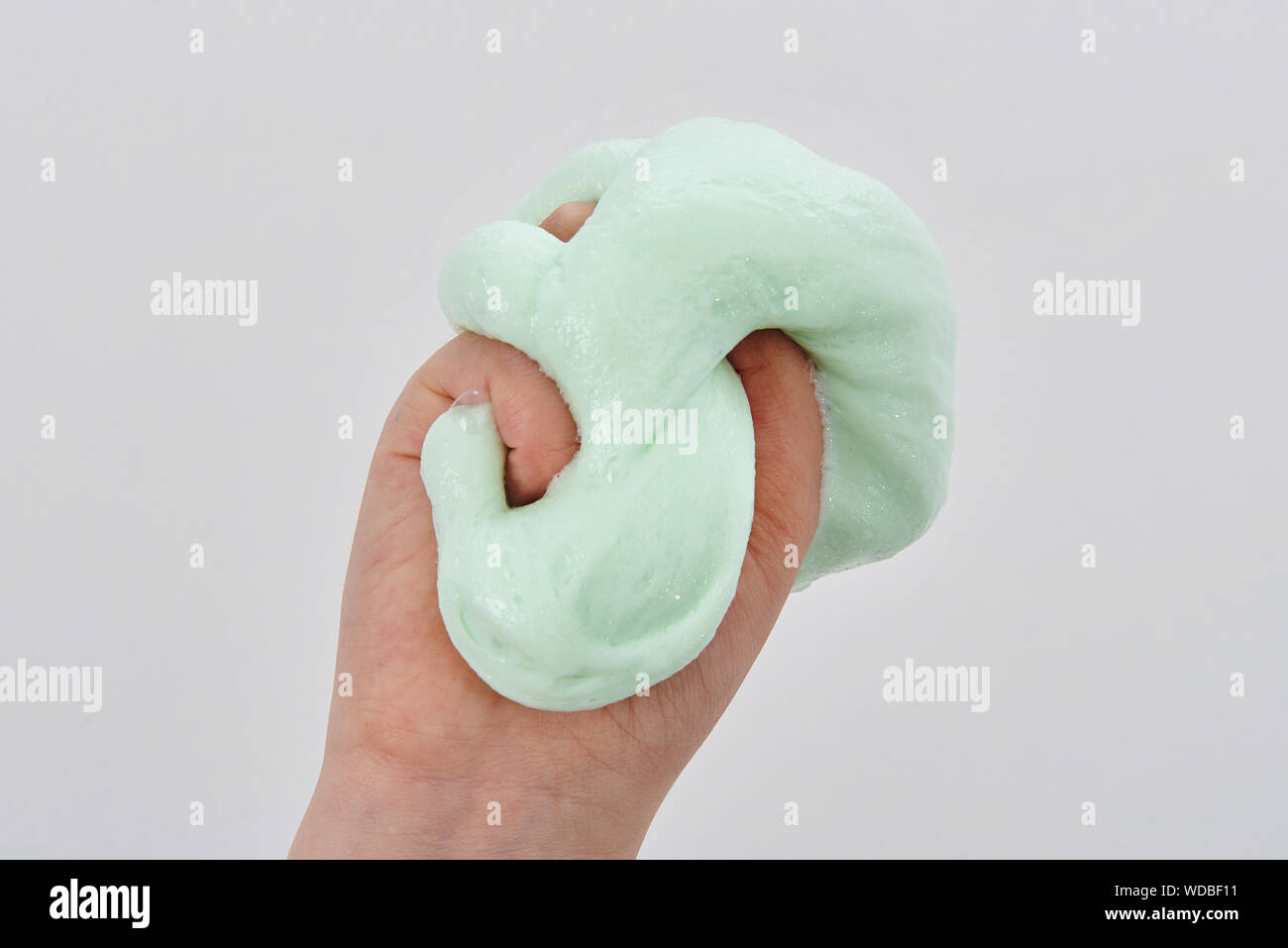 Hand squeezing green slime hi-res stock photography and images - Alamy