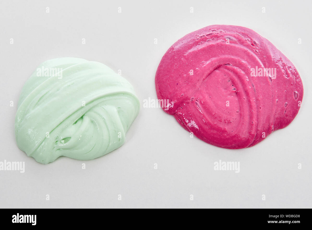 Two pieces of slime isolated on white background Stock Photo - Alamy