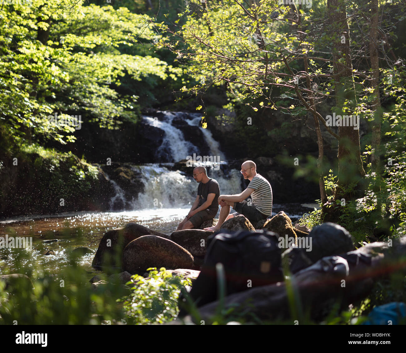 Two men on river rocks two men on river rocks hi-res stock photography ...