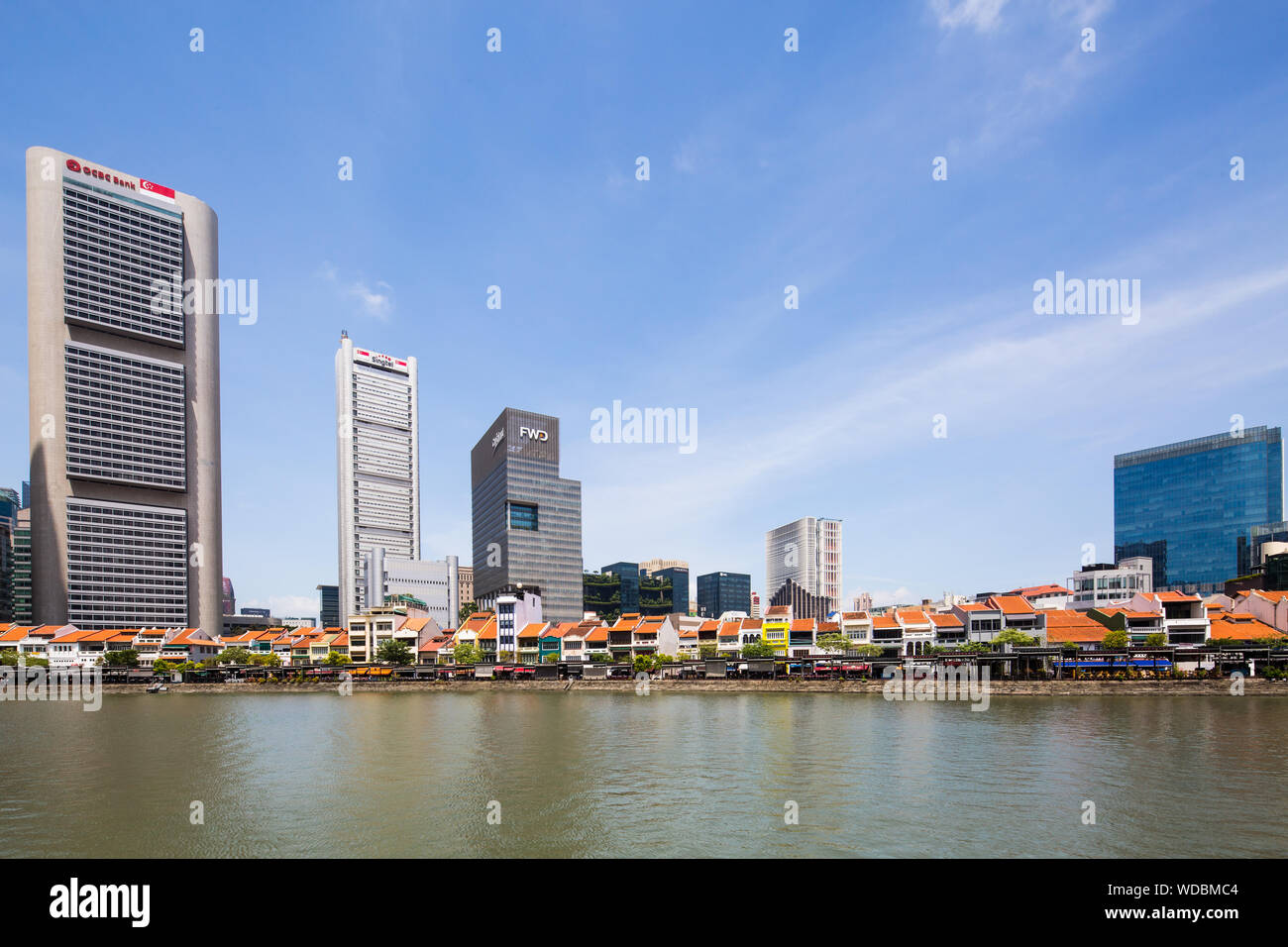 Wide view of Boat Quay shophouses, some skyscrapers and Singapore river ...