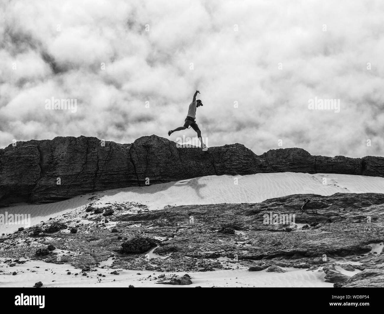 Side view man jumping in Black and White Stock Photos & Images - Alamy