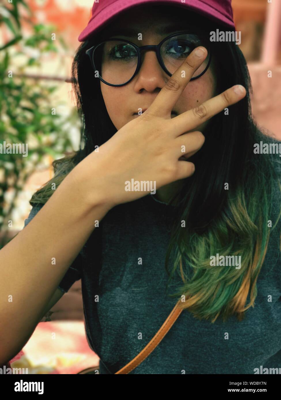 Portrait Of Woman Showing Peace Sign Stock Photo - Alamy