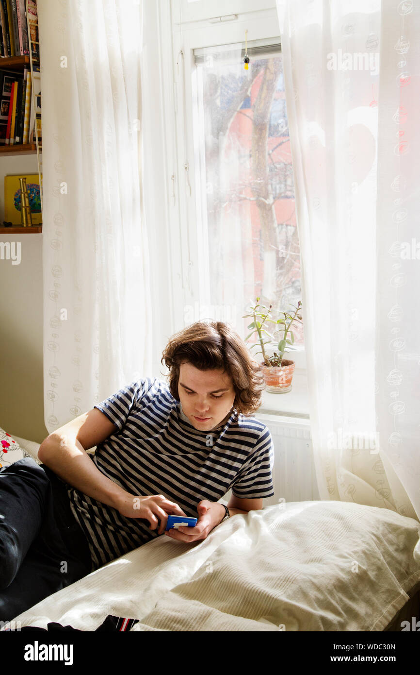 Man Looking Cell Phone Bed High Resolution Stock Photography and Images ...