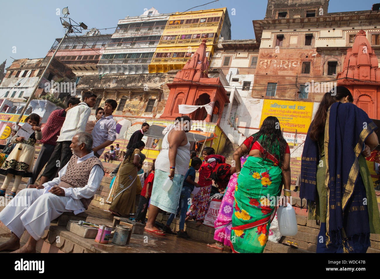 India, Uttar Pradesh, Varanasi, Pilgrims on the ghats beside the Ganges ...