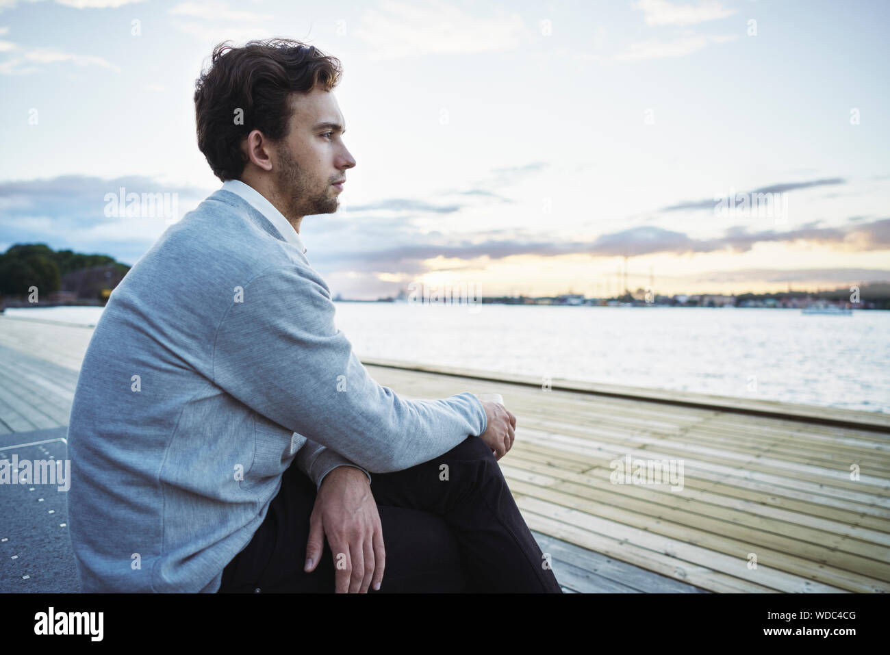 Young man by the sea hi-res stock photography and images - Alamy