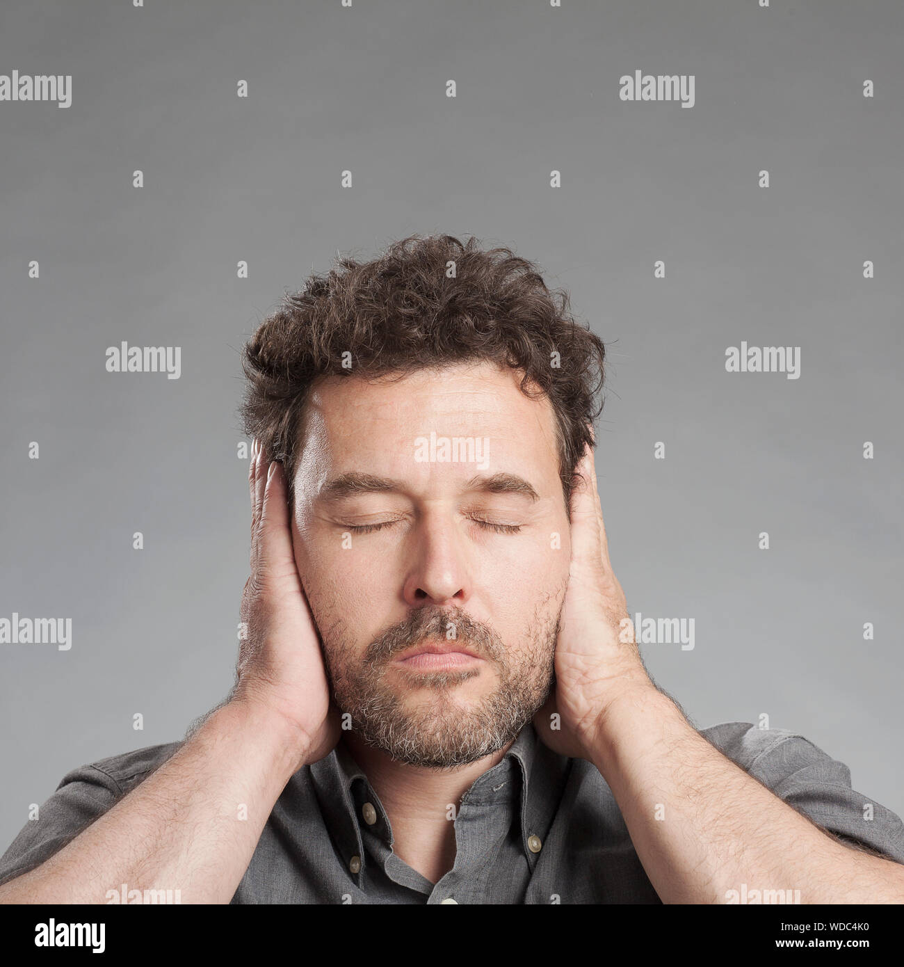 Hand covering ears hi-res stock photography and images - Alamy