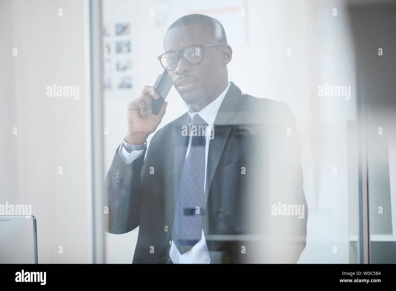 Businessman standing behind glass hi-res stock photography and images ...