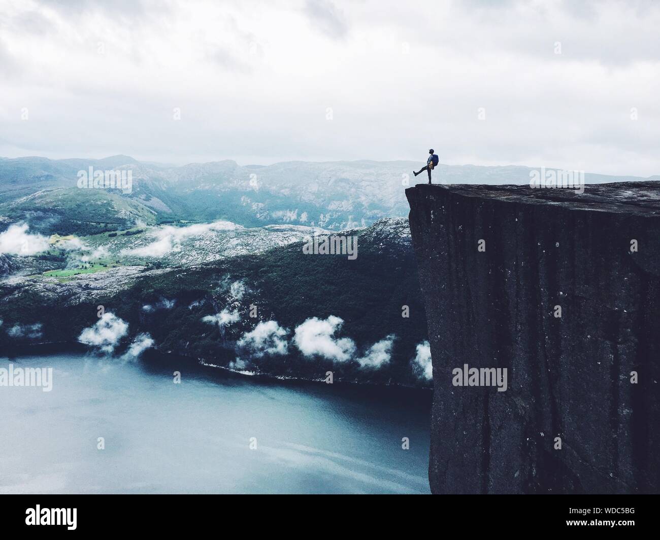 Person standing on cliff edge hi-res stock photography and images - Alamy