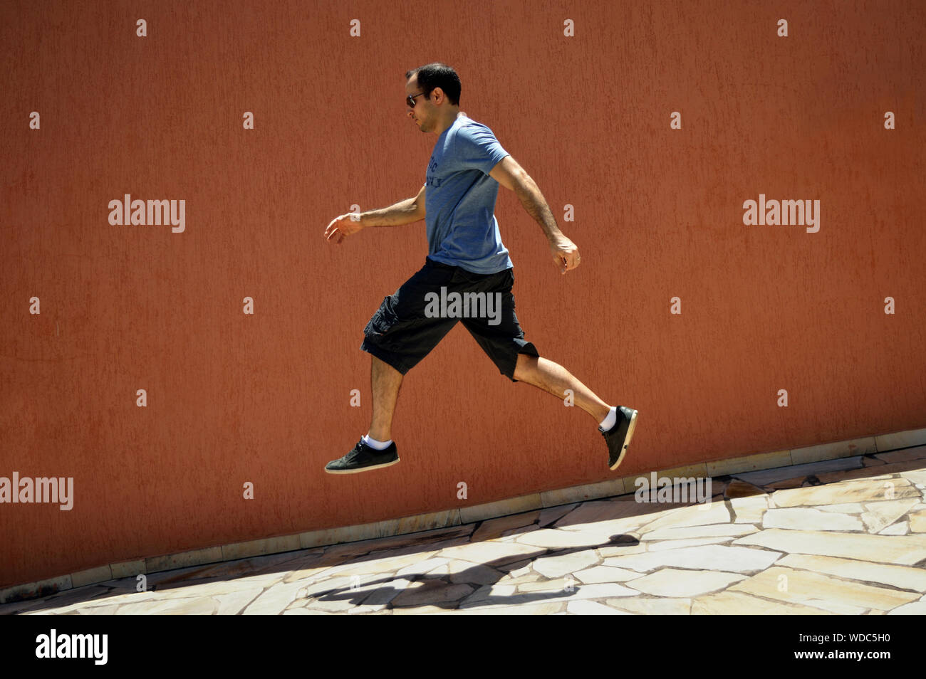 Man walking side view arms hi-res stock photography and images - Alamy