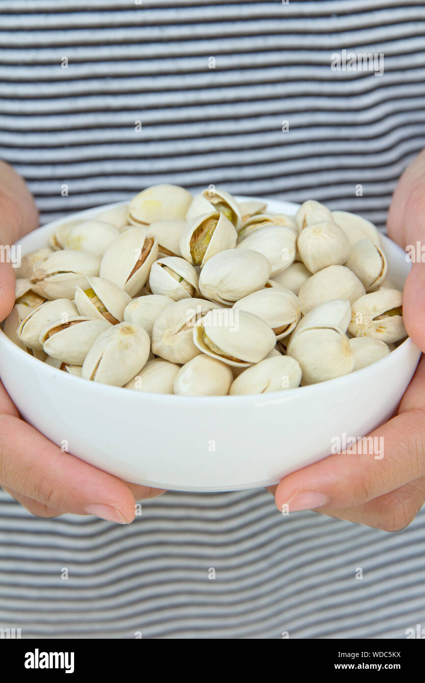 Hand holding nut bowl hi-res stock photography and images - Alamy