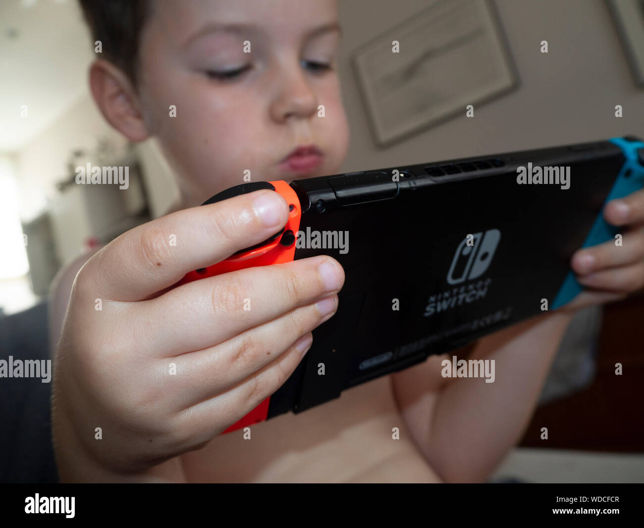 Child playing Nintendo Switch game Stock Photo - Alamy