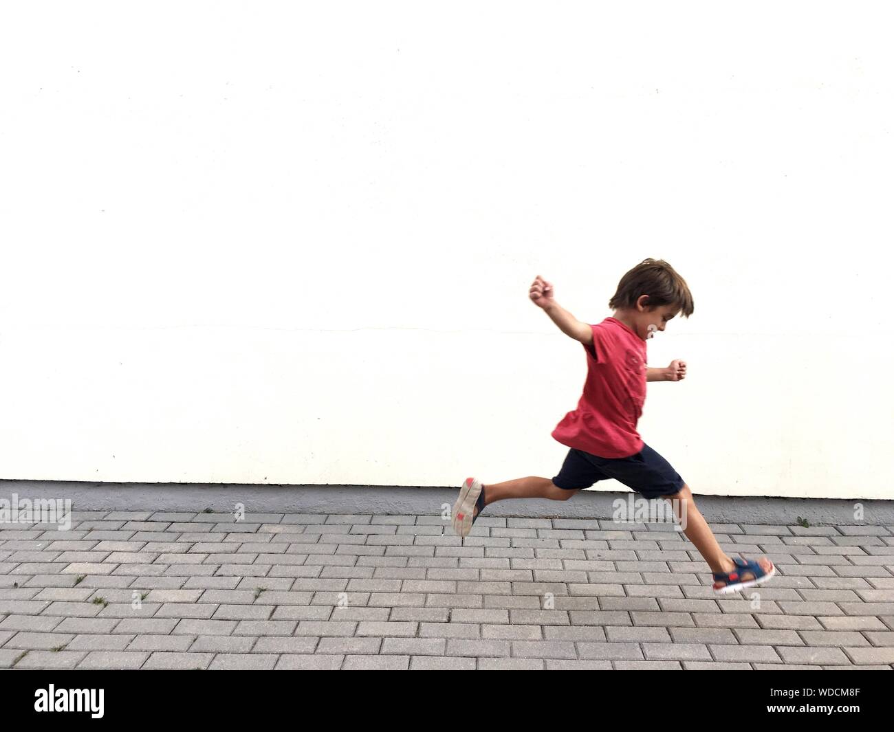 White boy running hi-res stock photography and images - Alamy