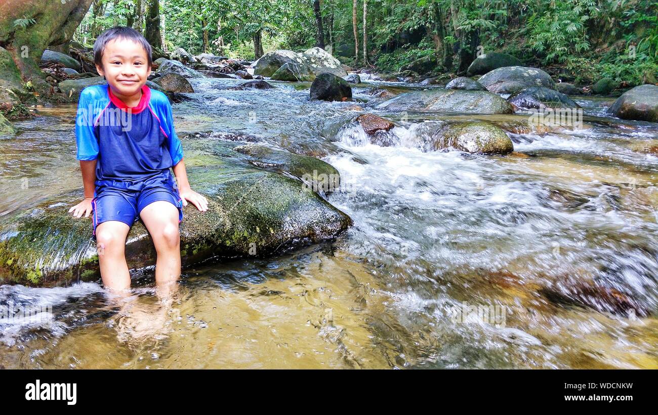 Boy sitting in river hi-res stock photography and images - Alamy