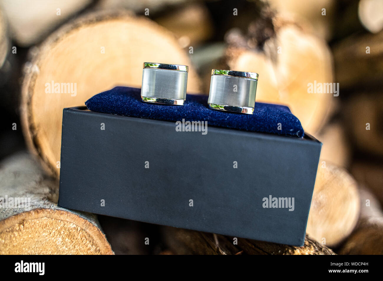 Silver cufflinks in a luxurious black box with velvet blue trim and a ...