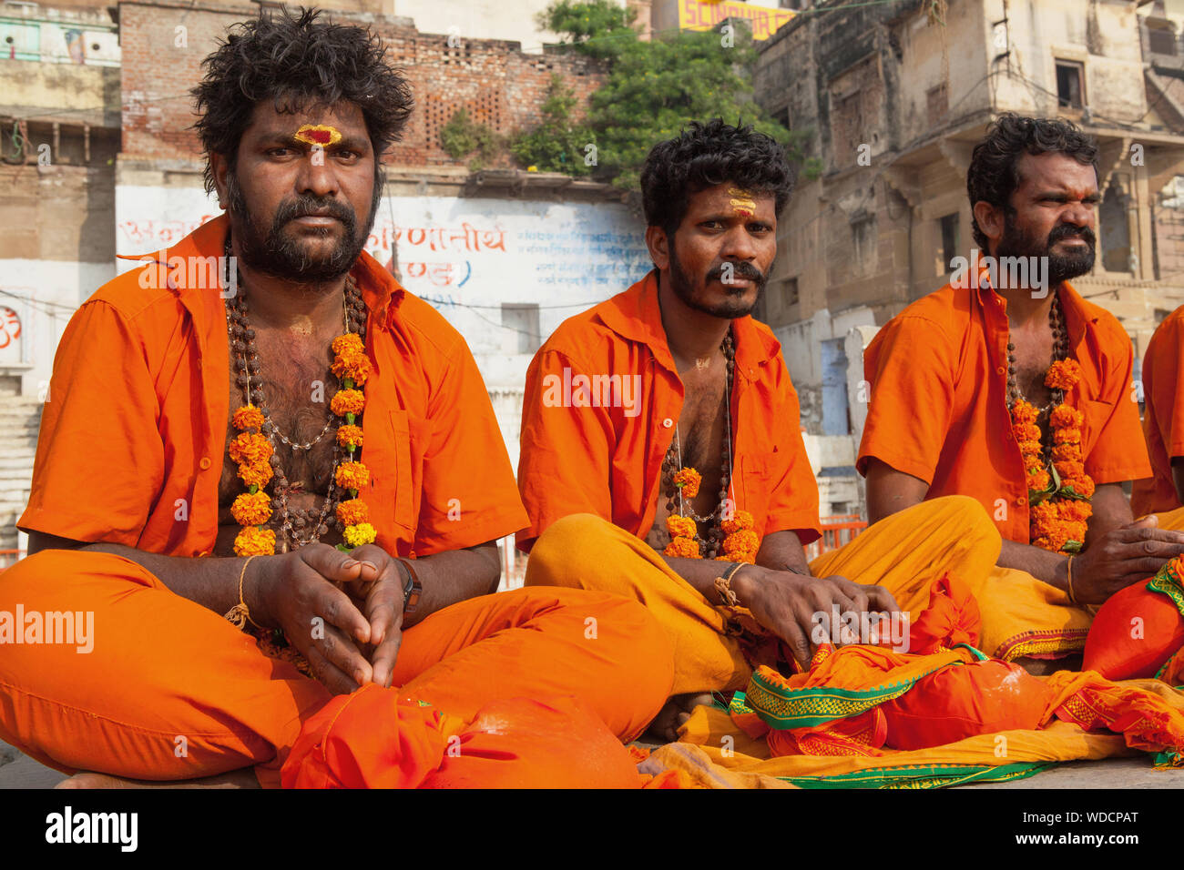 India, Uttar Pradesh, Varanasi, Pilgrims pray on the ghats beside the ...