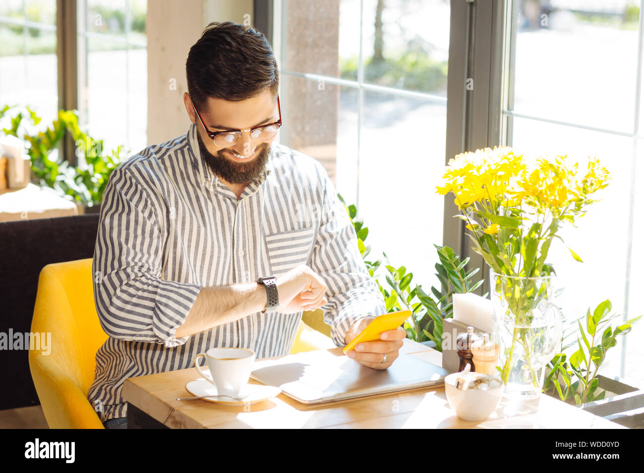 Positive good looking man checking the time Stock Photo - Alamy