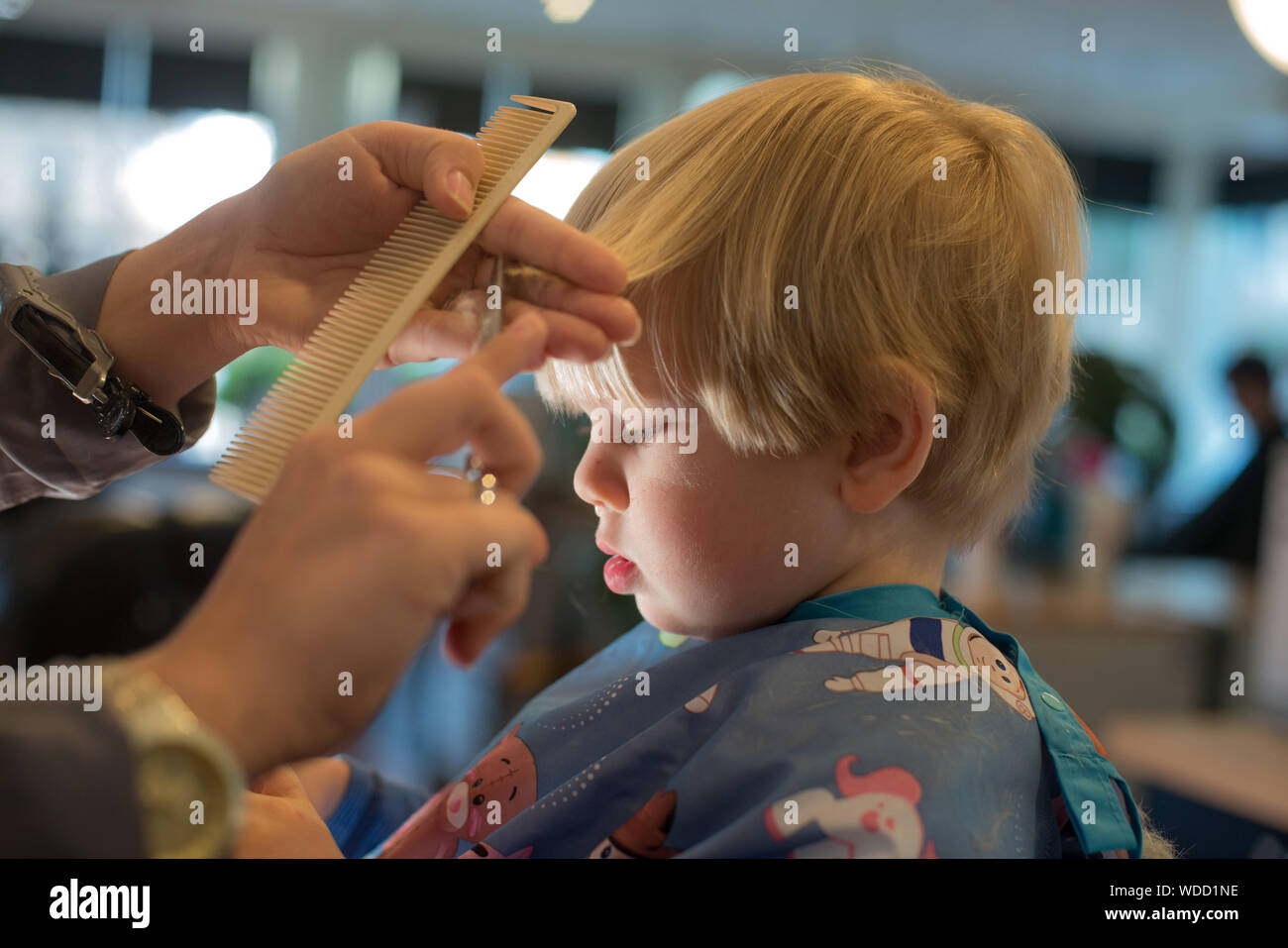 Barber cutting boy hair hi-res stock photography and images - Alamy